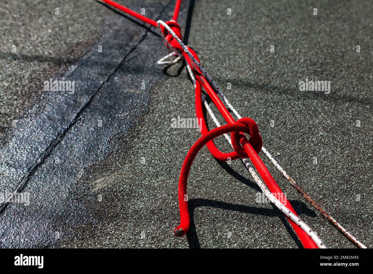 Connecting the rope to the climbing harness . Rope for industrial ...