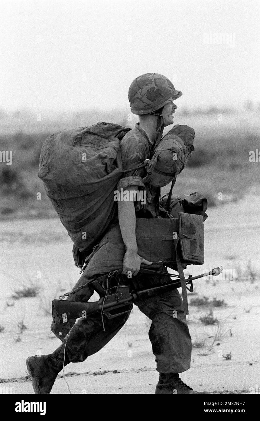 A paratrooper from the 82nd Airborne Division moves out into the field ...