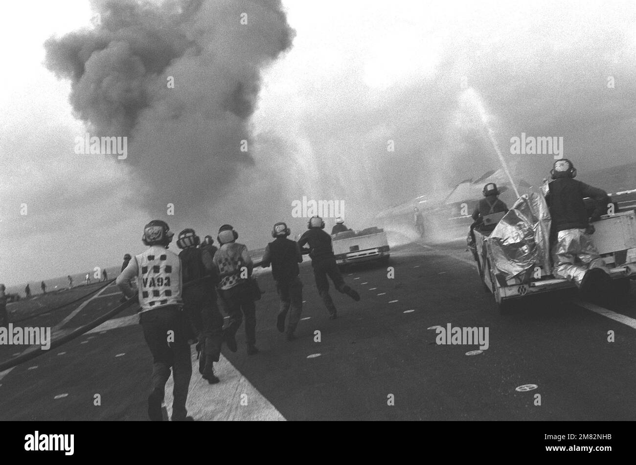 Flight deck crewmen respond to an emergency on the aircraft carrier USS ...