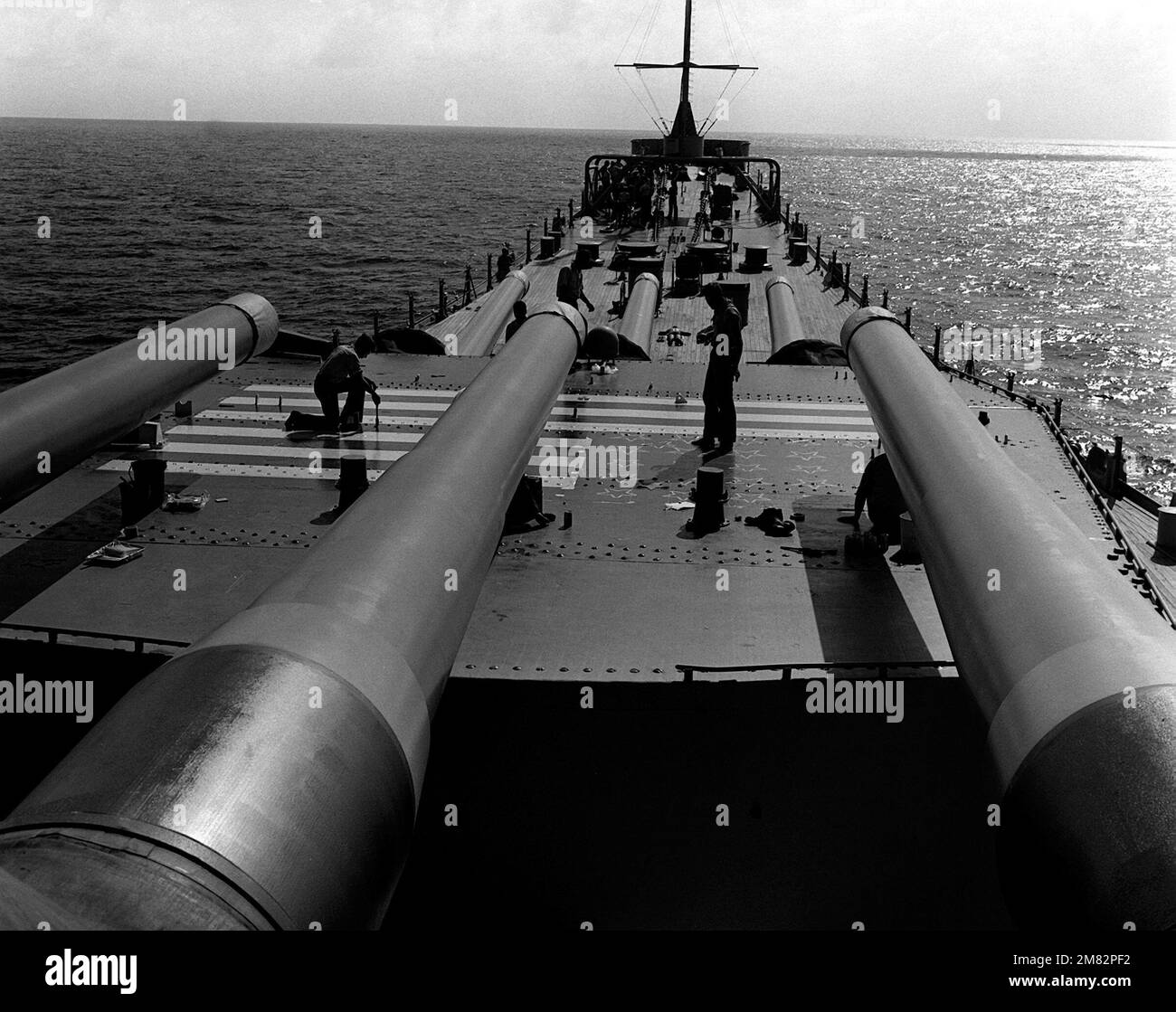 Crew members paint the U.S. flag on top of the No. 1 Mark 7 16-inch/50 ...