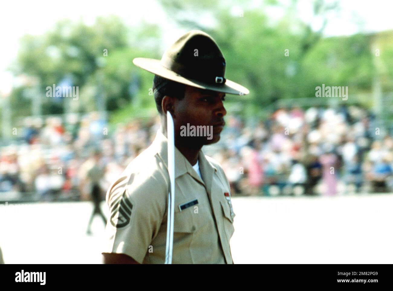 A Marine drill instructor stands at attention with a sabre during a ...