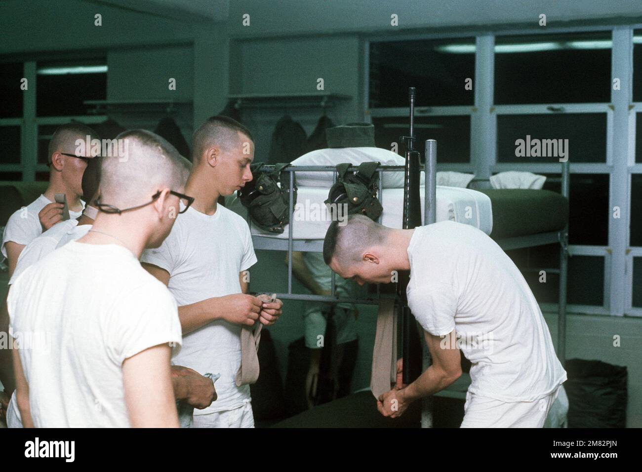 Marine recruits prepare their uniforms for a barracks inspection during ...