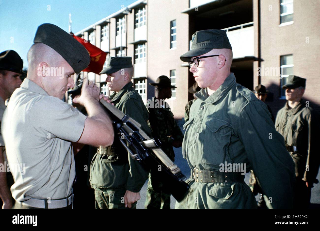 A Marine first lieutenant inspects a recruit's M16A1 rifle during basic ...