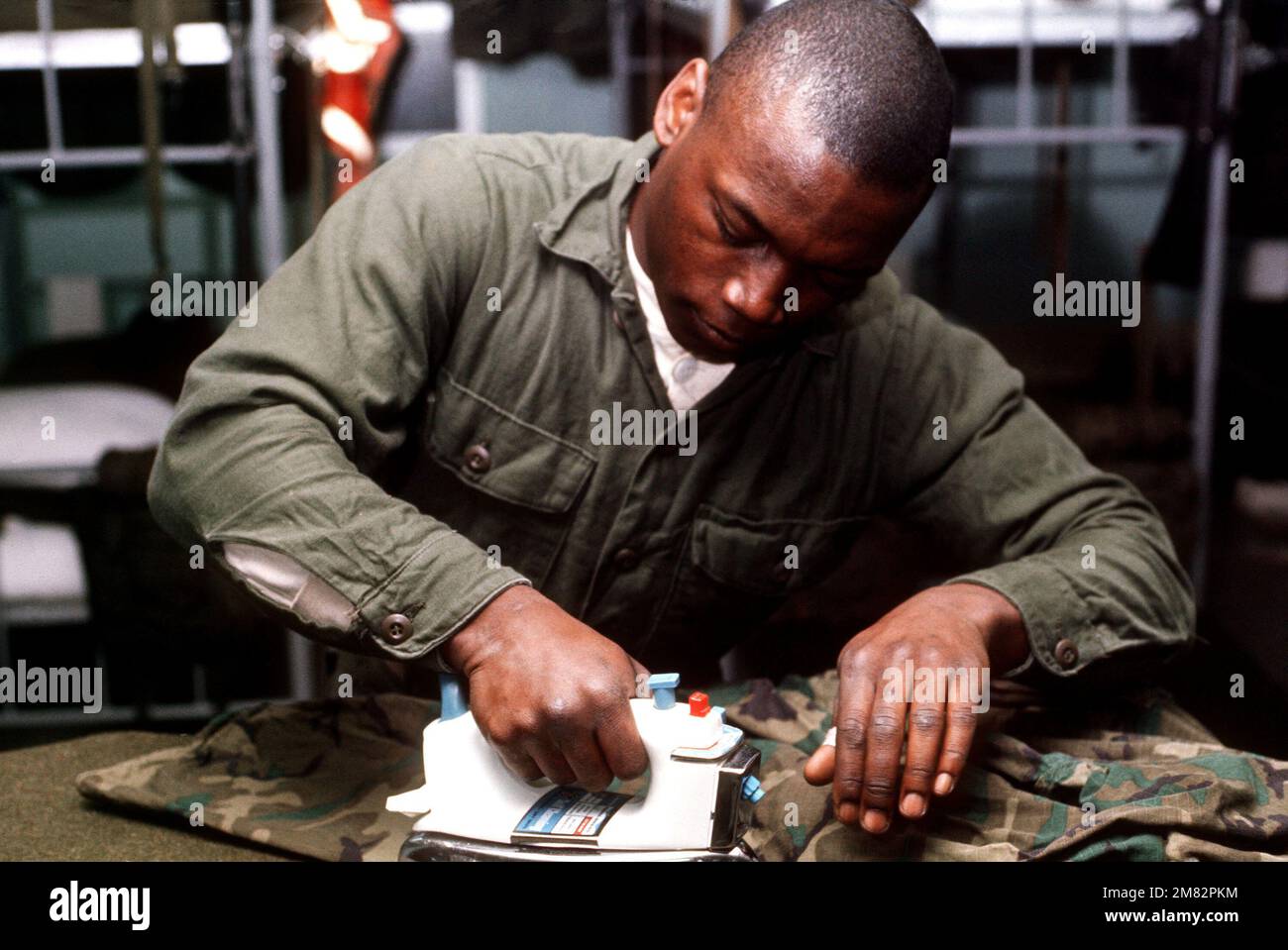 A Marine recruit irons his uniform in preparation for an inspection ...