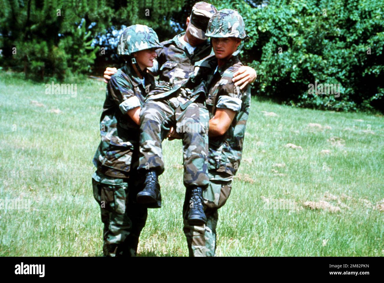 Two Marine recruits practice the proper way to carry a "wounded" fellow ...