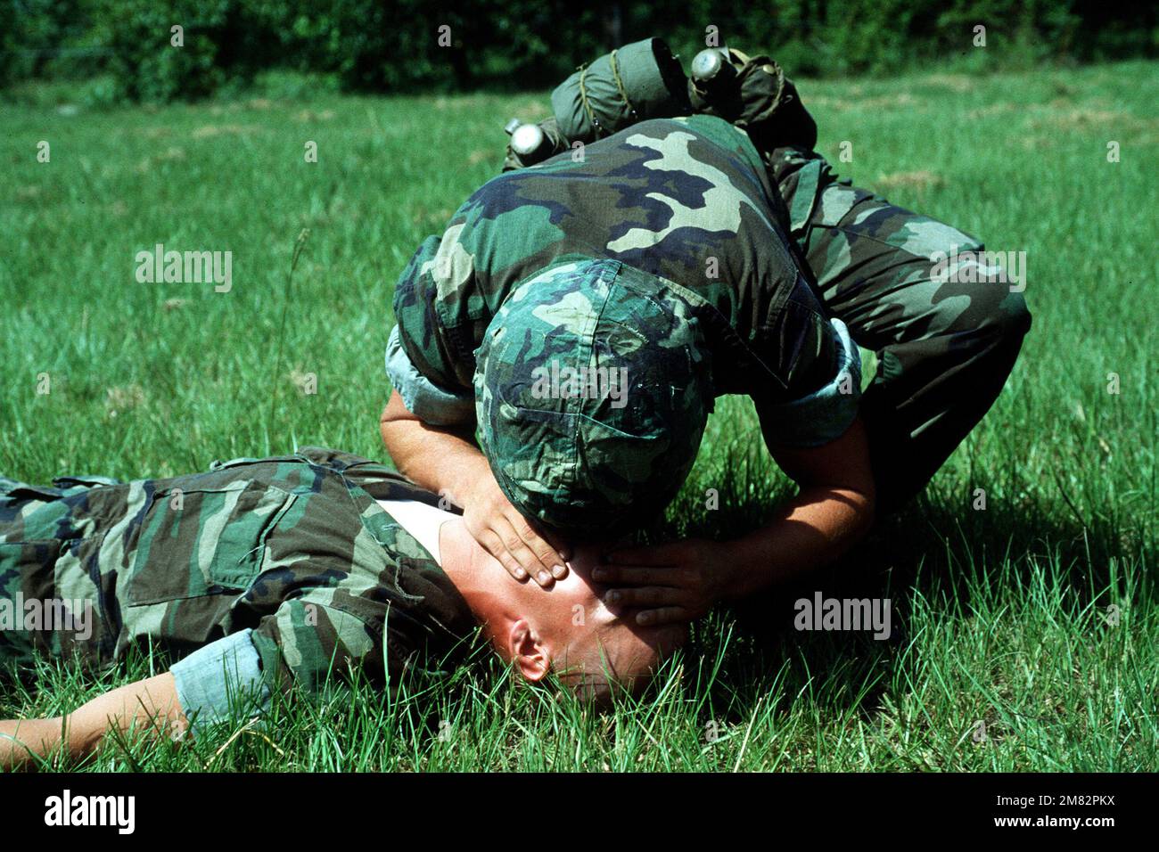A Marine recruit performs mouth-to-mouth resuscitation on a "wounded ...