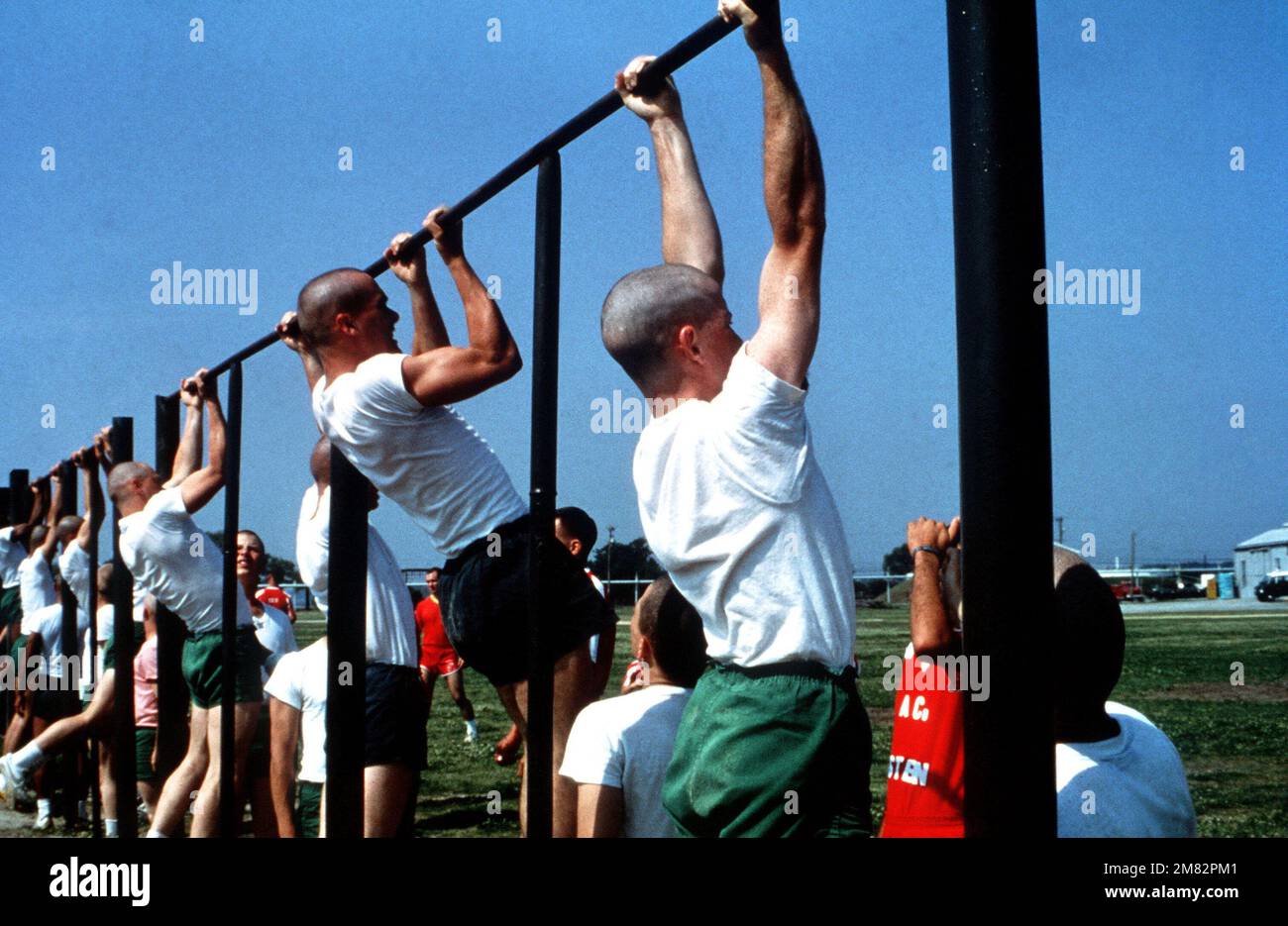 Marine recruits perform pull up exercises during basic training at the ...