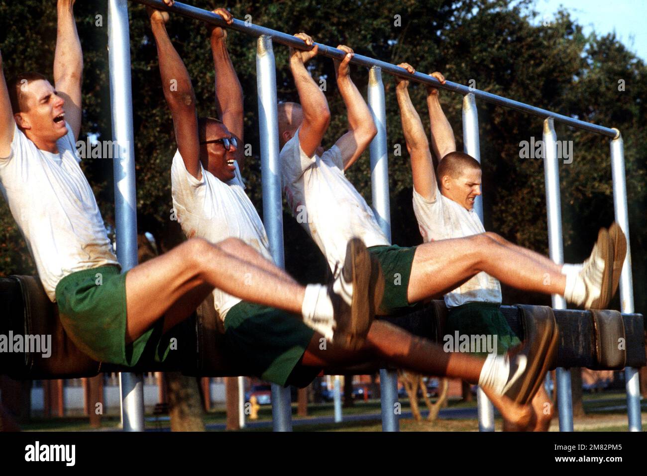 Marine recruits perform leg lift exercises during basic training at the ...