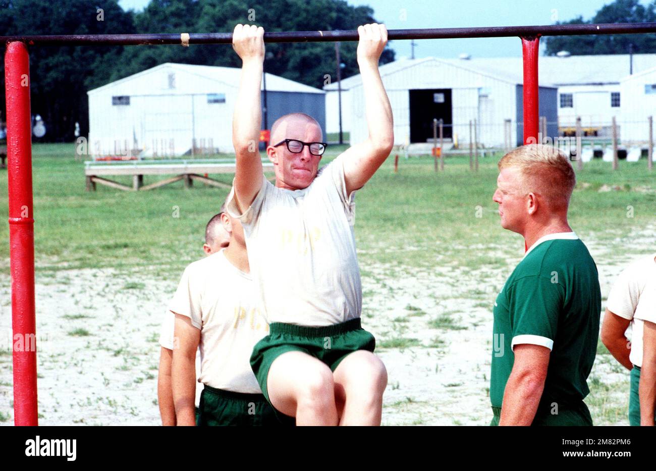 A Marine recruit performs pull ups during physical training at the ...