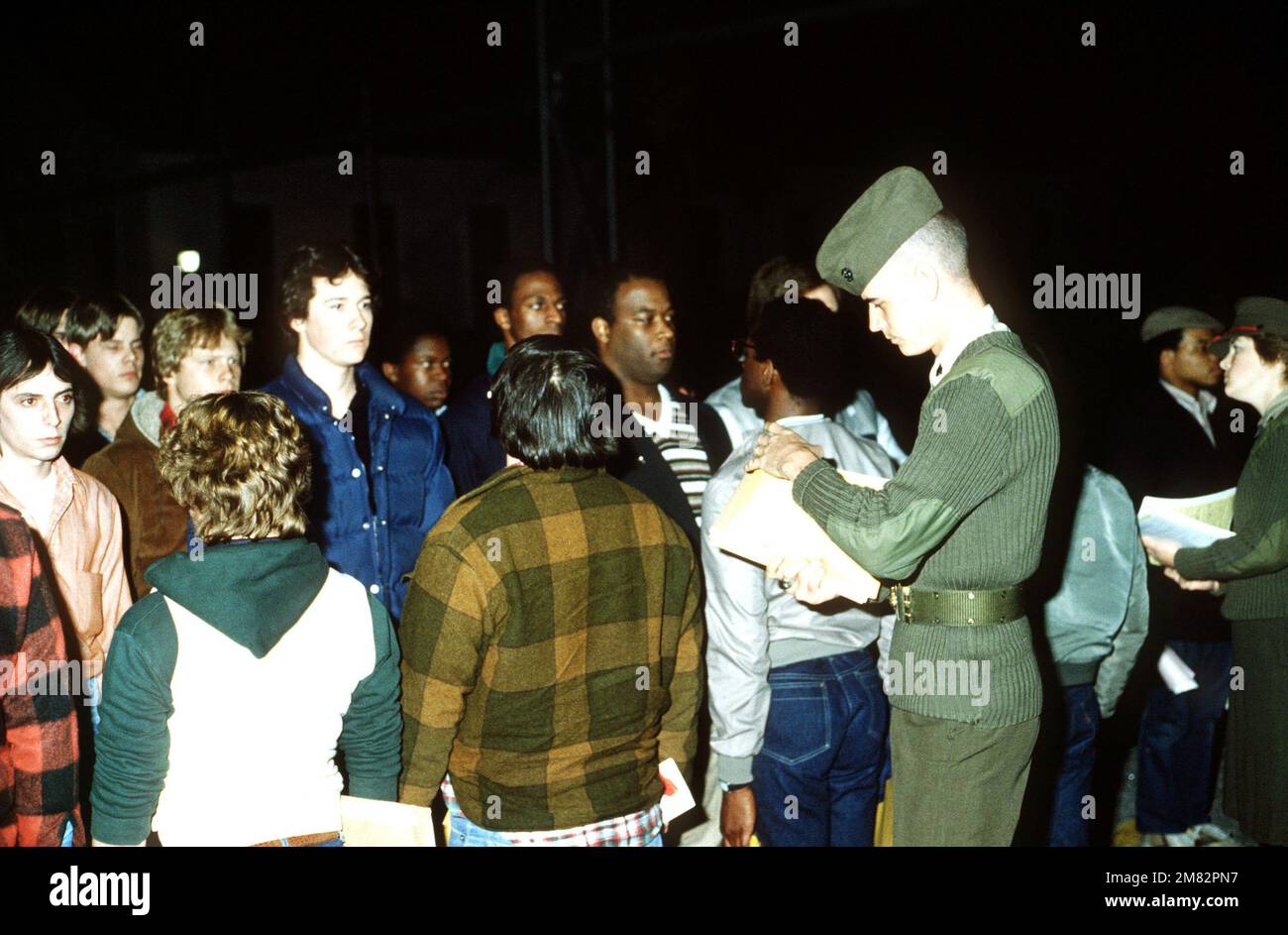 Marine recruits receive processing papers as they arrive to begin basic ...