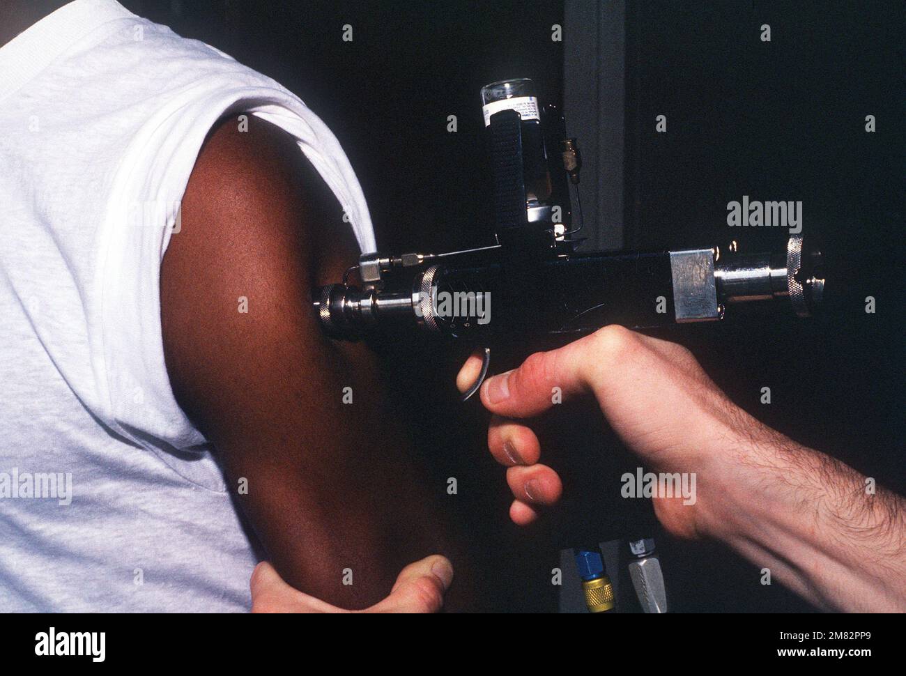 A Marine recruit receives an immunization shot during his medical ...