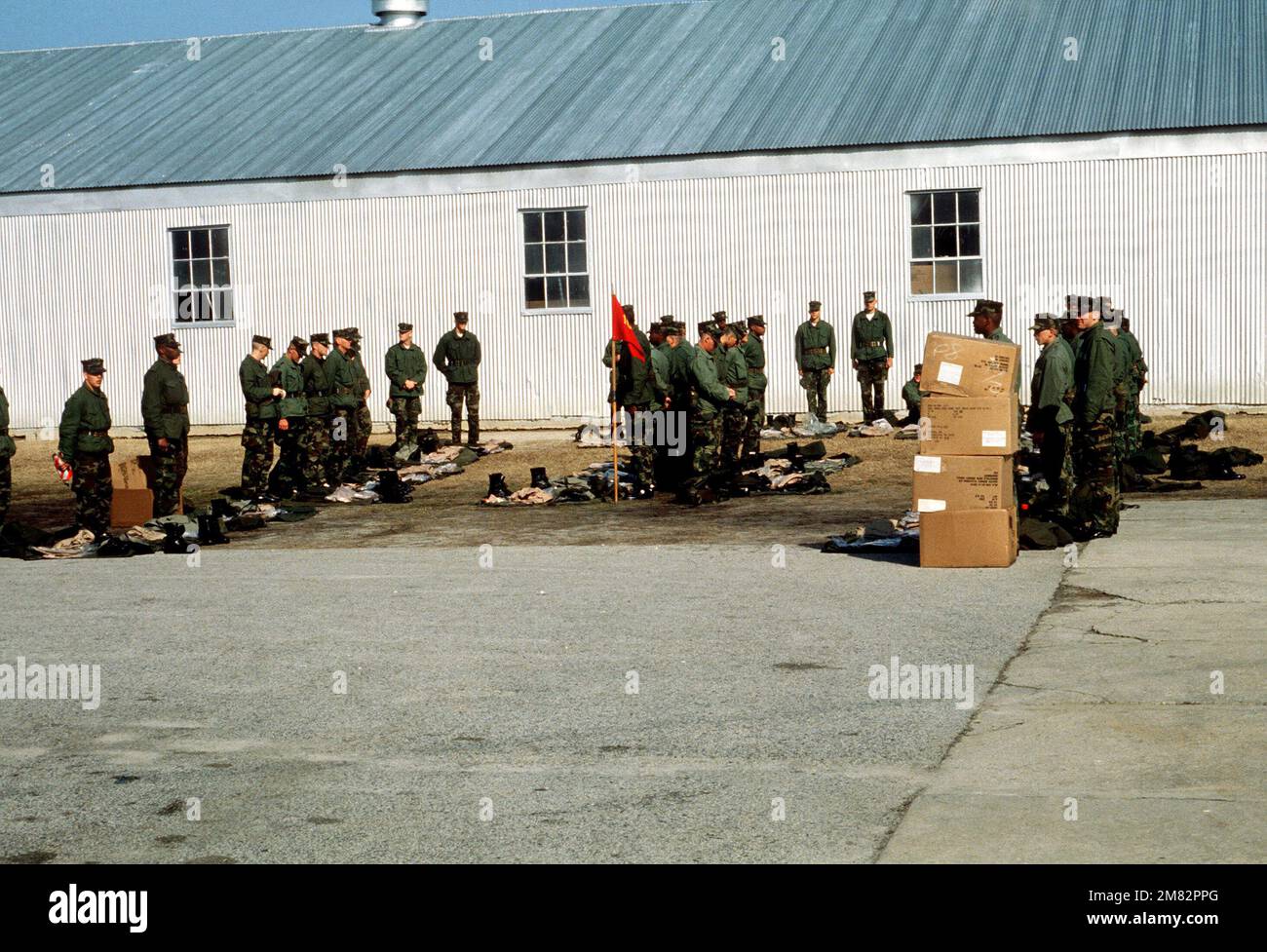 Marine recruits stand in ranks for uniform issue as they begin basic ...