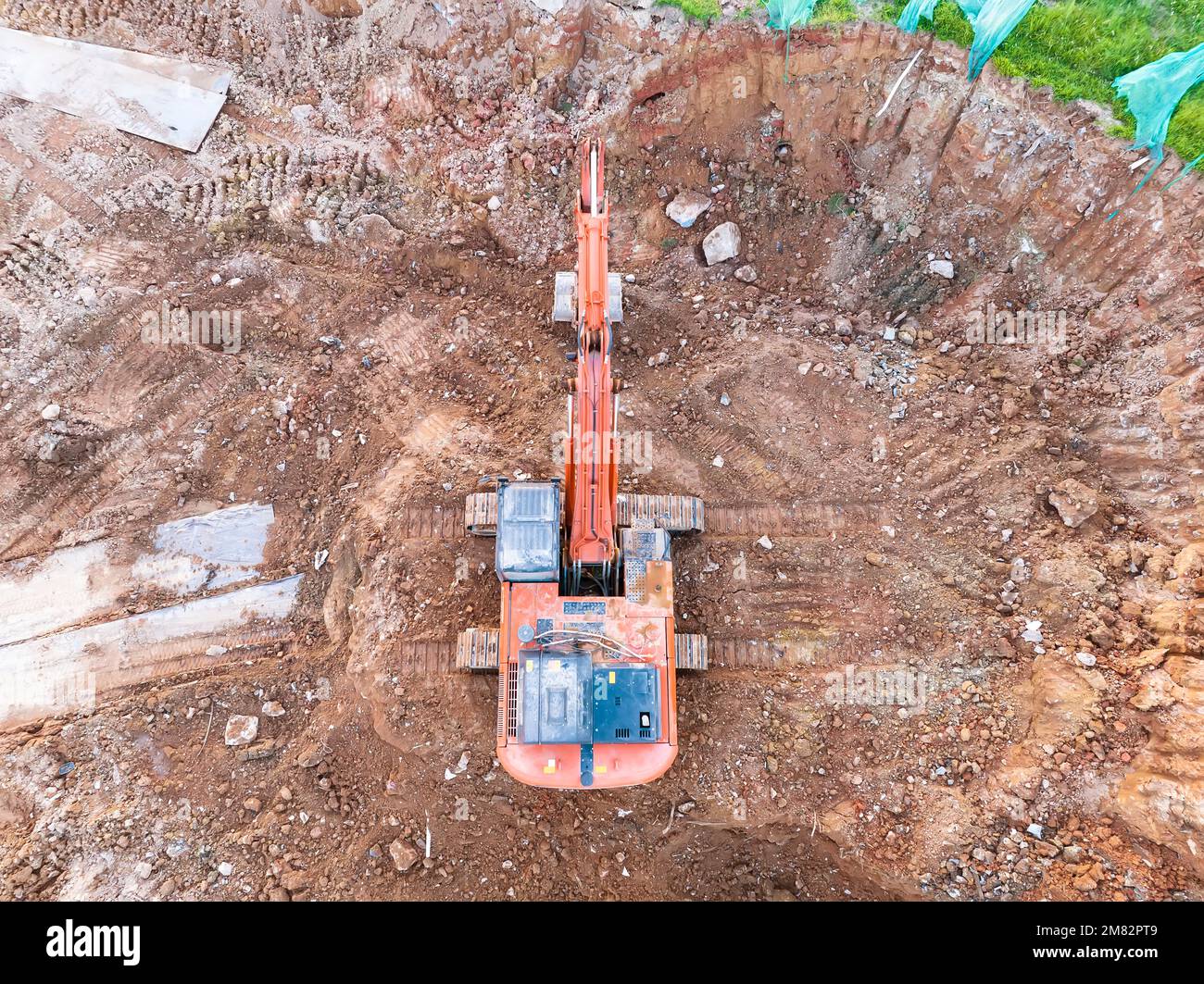 Excavator on earthmoving at construction site, aerial view Stock Photo ...