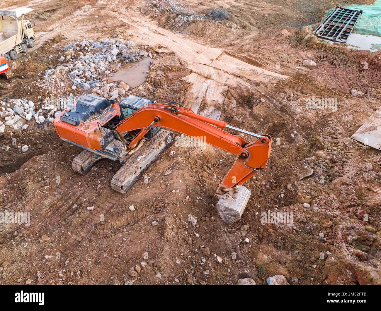 Excavator on earthmoving at construction site, aerial view Stock Photo ...