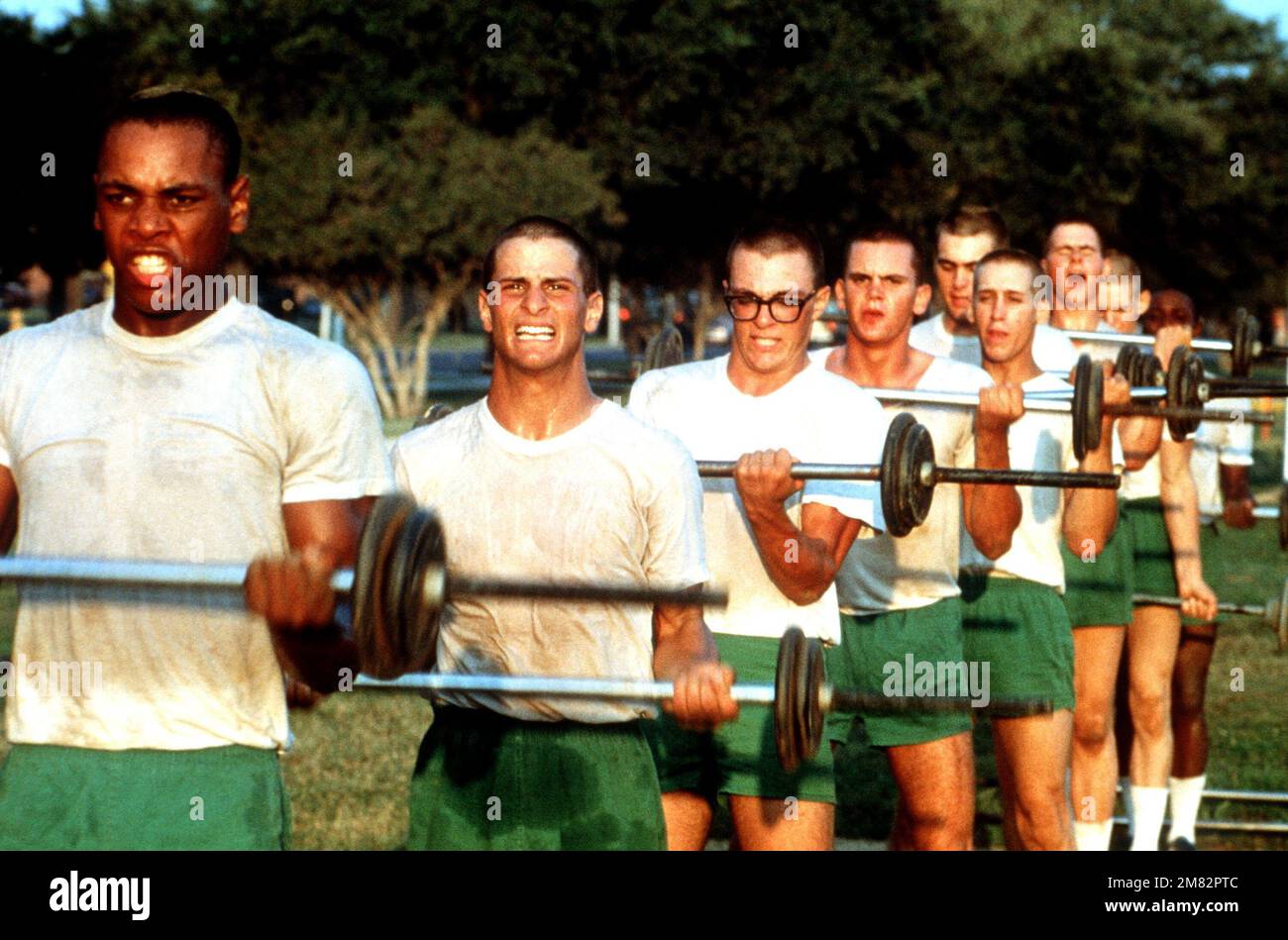 Marine recruits perform weight lifting exercises during basic training ...