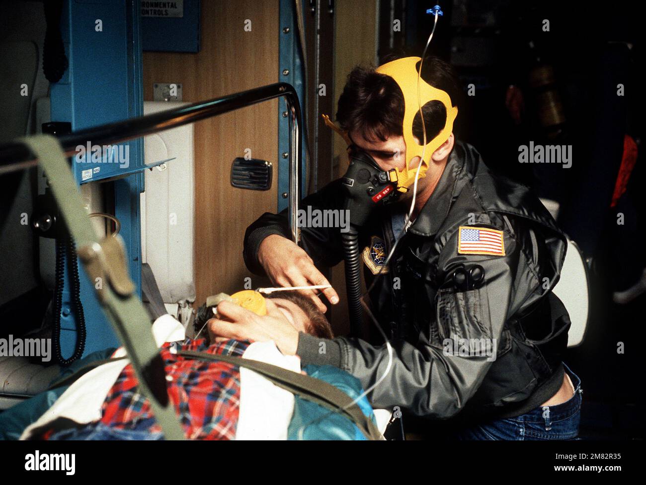 A member of the 2nd Aeromedical Evacuation Squadron helps a "patient ...