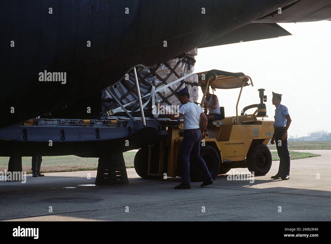 Brazilian military personnel use a fork lift to load a pallet of ...