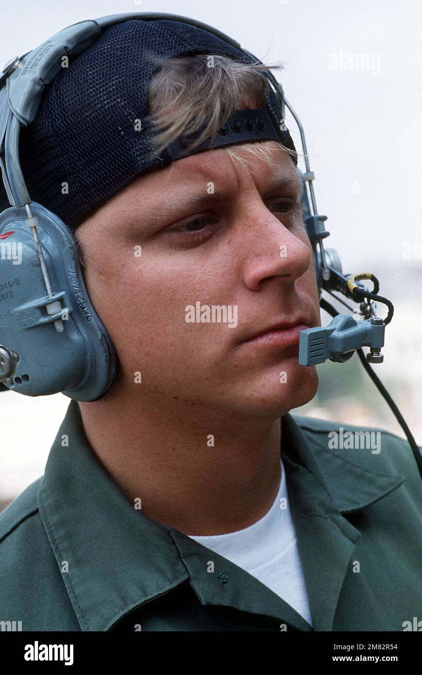 A member of the 50th Tactical Airlift Squadron wears a headset while ...