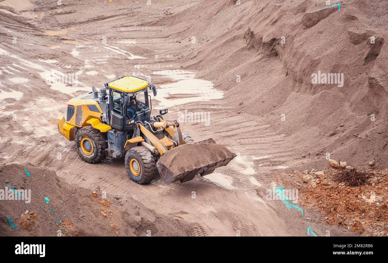 excavator loader machine during earthmoving works outdoors Stock Photo ...