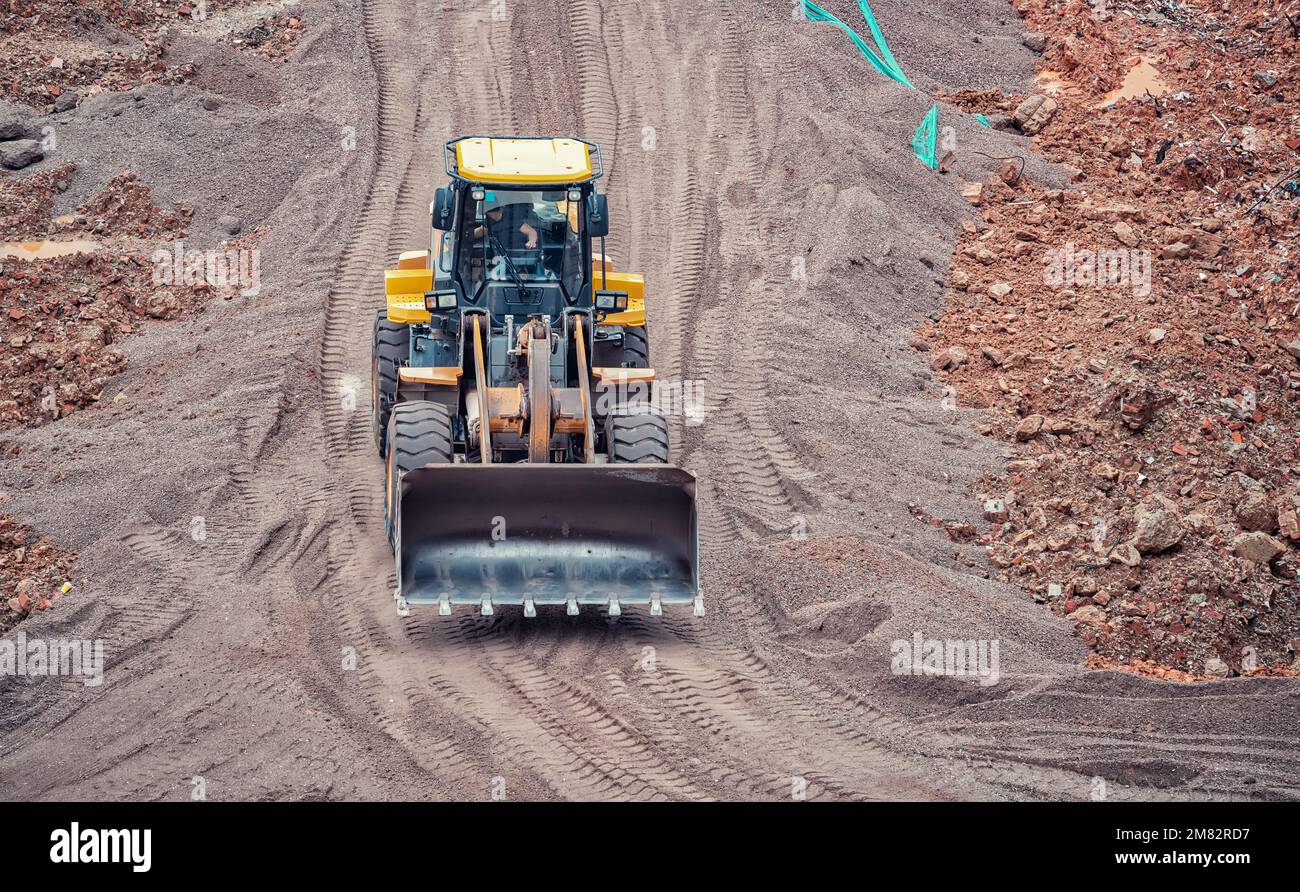 excavator loader machine during earthmoving works outdoors Stock Photo ...