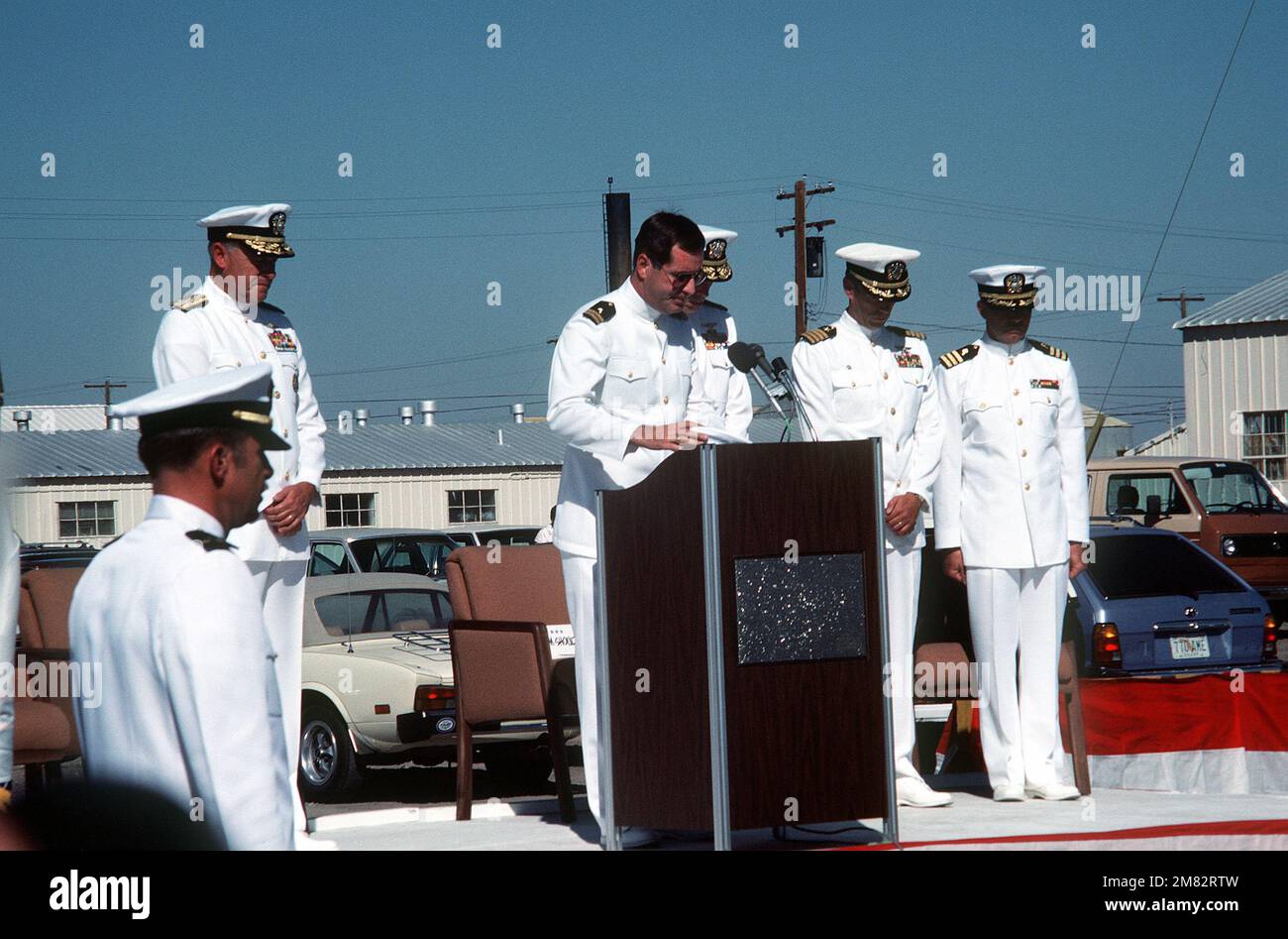 A Navy chaplain offers the invocation during the commissioning of the ...
