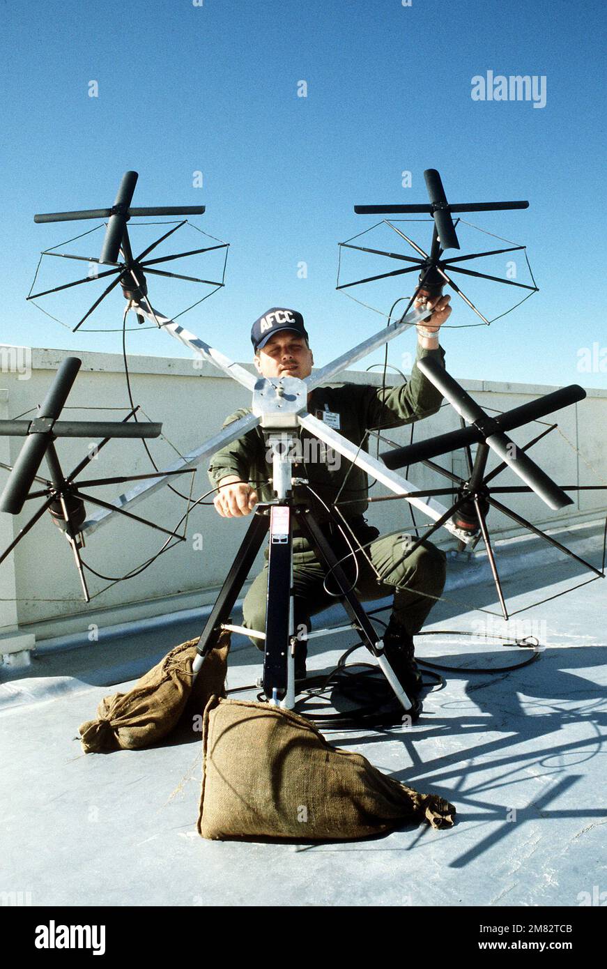 A member of the 13th Air Force command center sets up a satellite ...