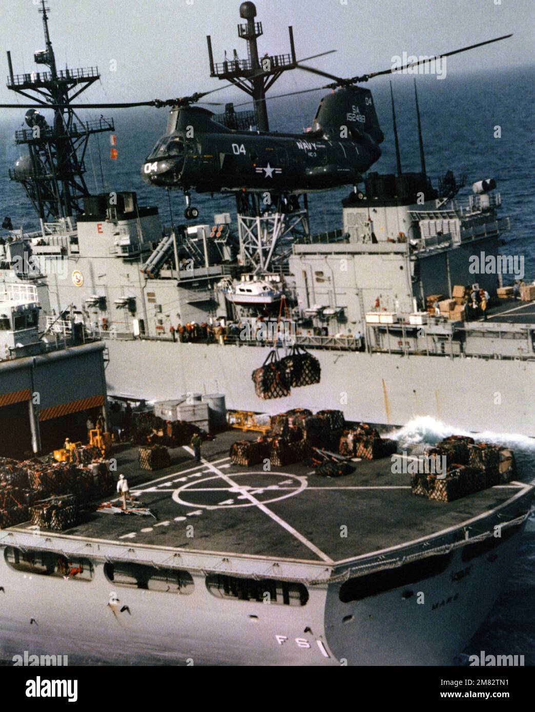 Left front view of a CH-46 Sea Knight helicopter as it is used to lift ...