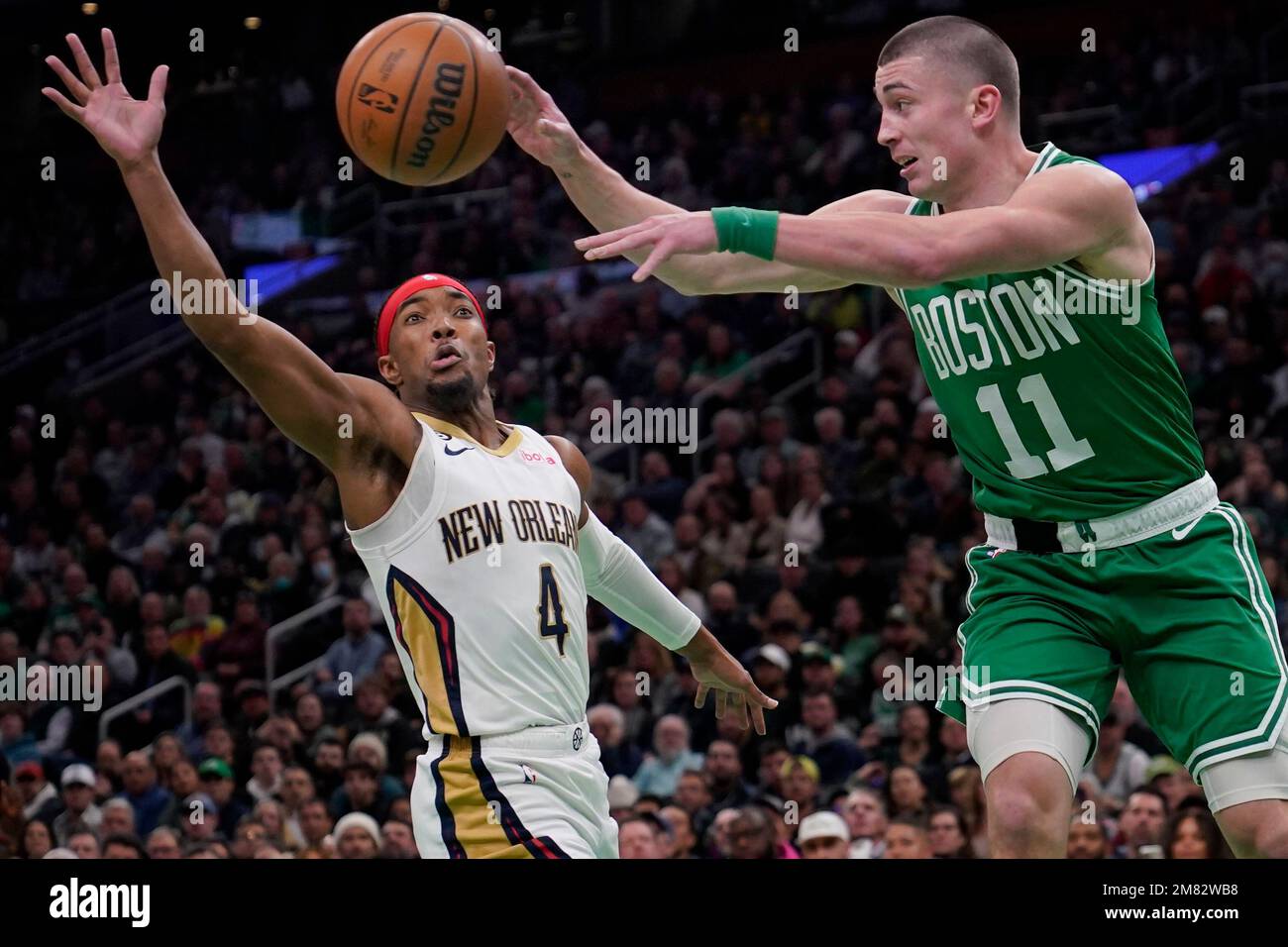 Boston Celtics guard Payton Pritchard (11) passes the ball while pressured by New Orleans ...