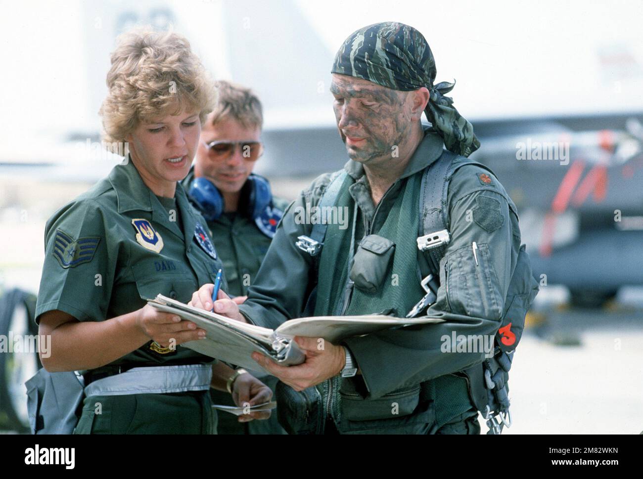 STAFF SGT. Kimberly Davis helps a pilot fill out a log book during the ...