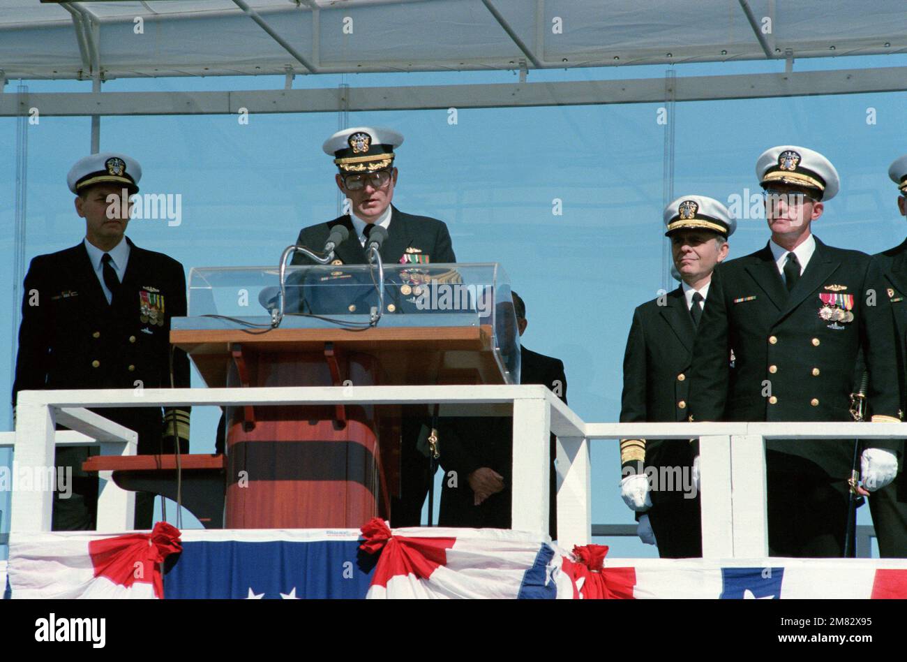 On the speakers platform are, right to left: Captain M. Farmer ...