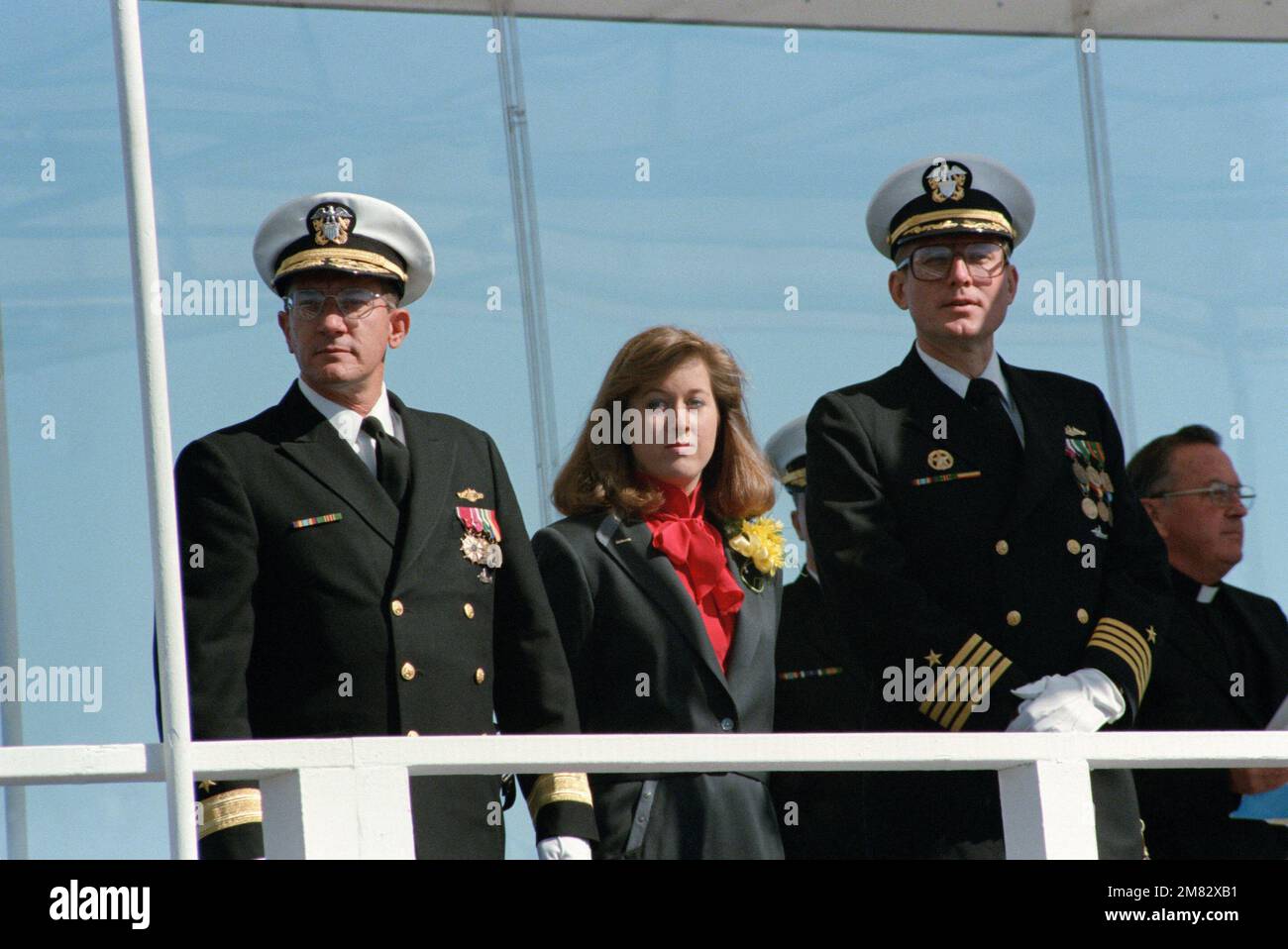 Anne Marine Jackson, sponsor, stands between the commissioning officers ...