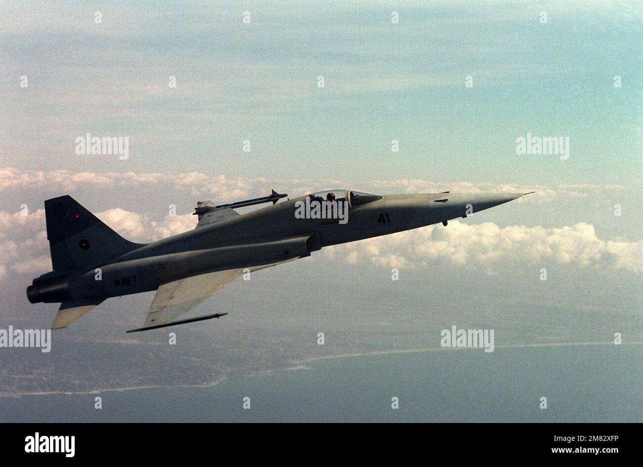 An air-to-air right side view of an F-5 Tiger II aircraft. The aircraft ...