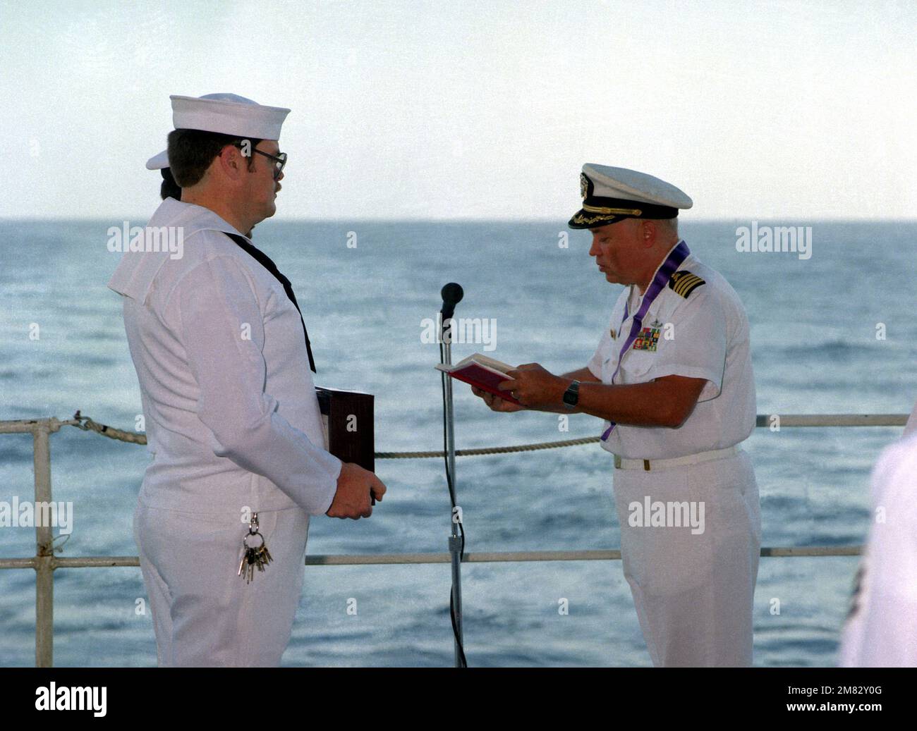 Chaplain (CAPT.) Lester L. Westling conducts a burial at sea service ...