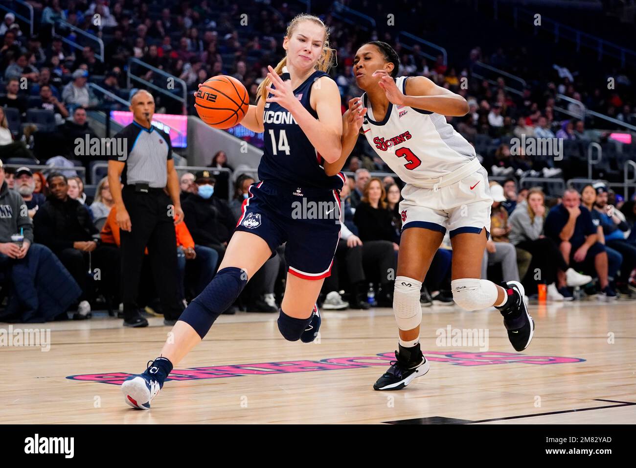 St. John's Jillian Archer (14) drives past St. John's Danielle ...