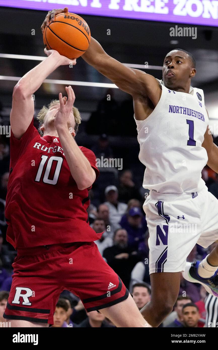 Northwestern guard Chase Audige, right, blocks a shot by Rutgers guard ...