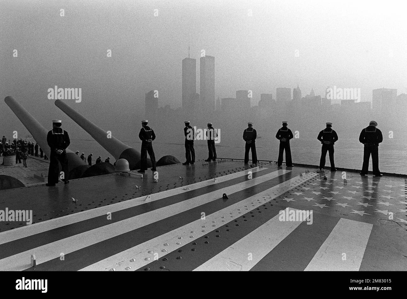 Crewmen man the rail and the top of the housing of the forward Mark 7 ...