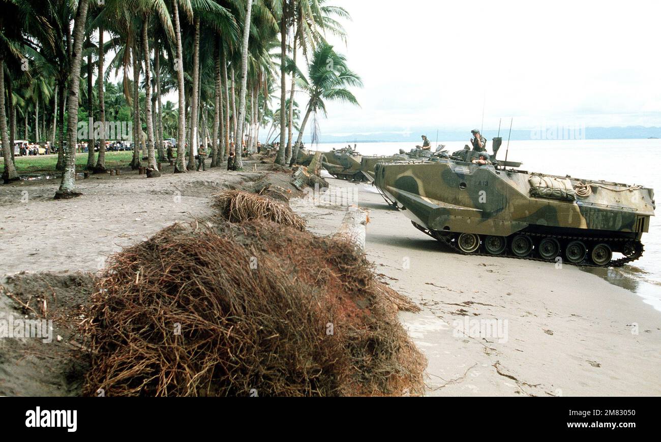 Marine Corps personnel tracked landing vehicles (LVTP7) come ashore at ...
