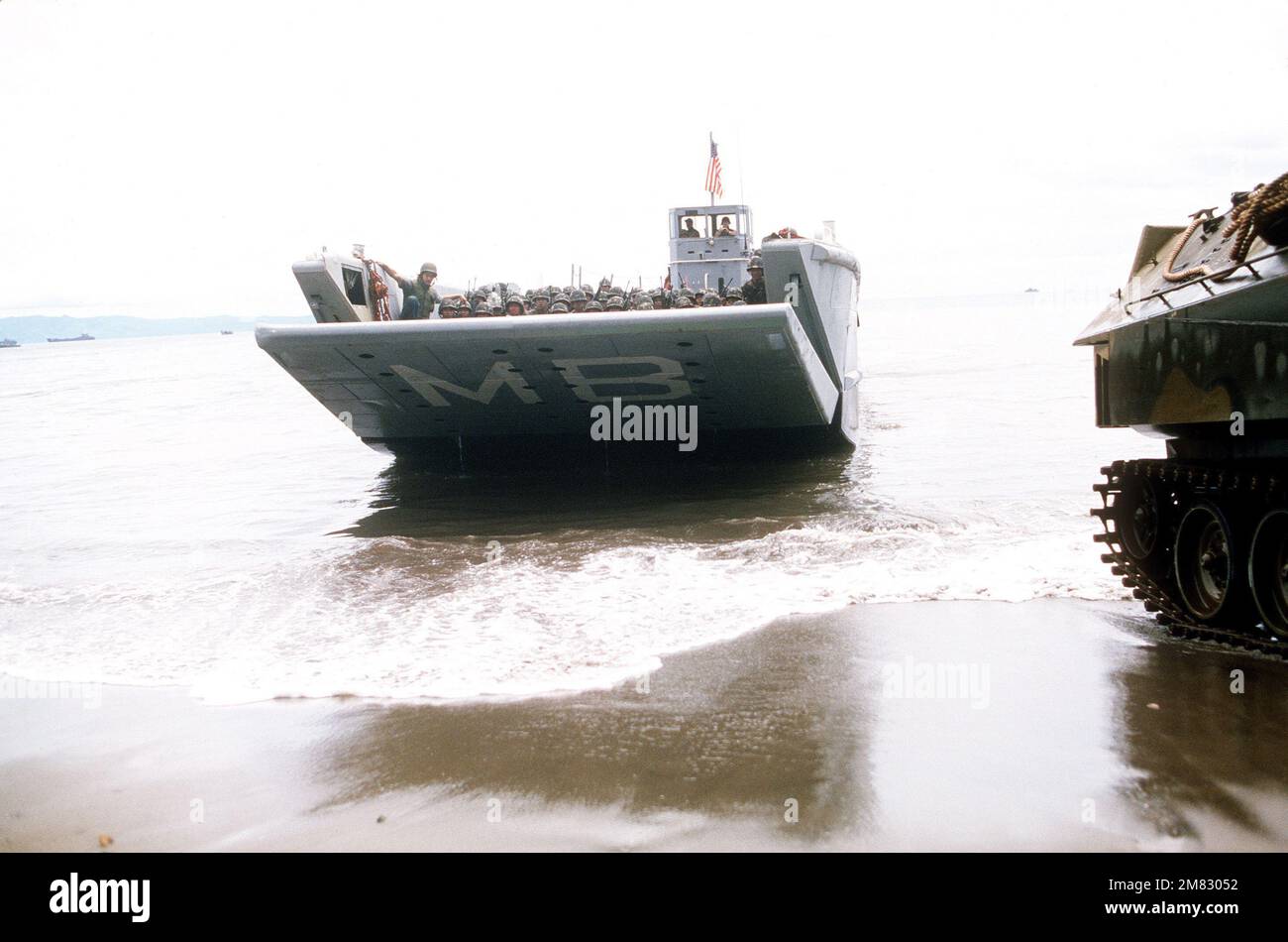 Philippine Marines come ashore from a mechanized landing craft (LCM 8 ...