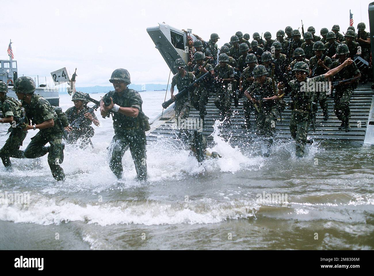 Philippine marines come ashore from a mechanized landing craft (LCM-8 ...