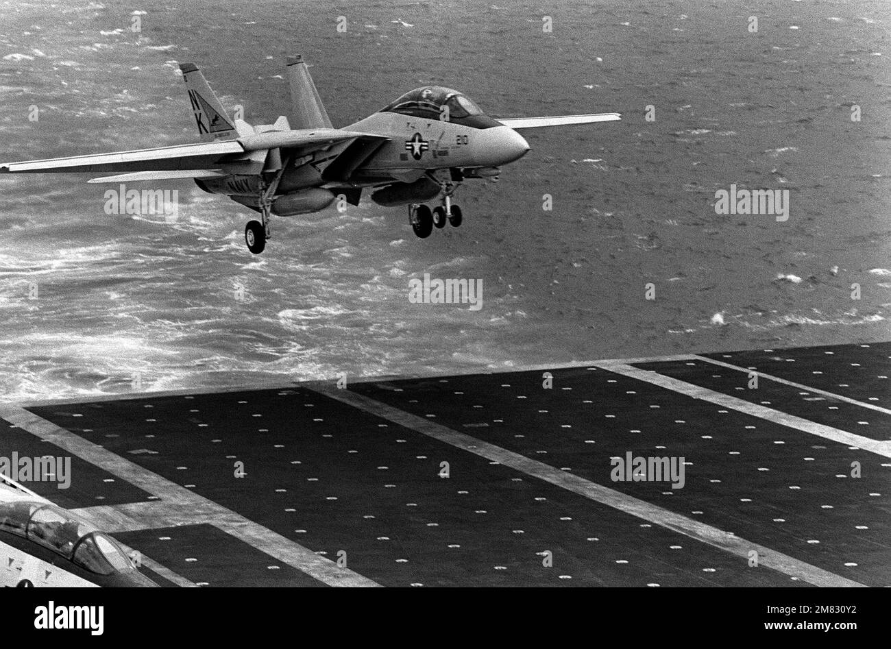 An F-14A Tomcat aircraft from Fighter Squadron 21 prepares to land ...