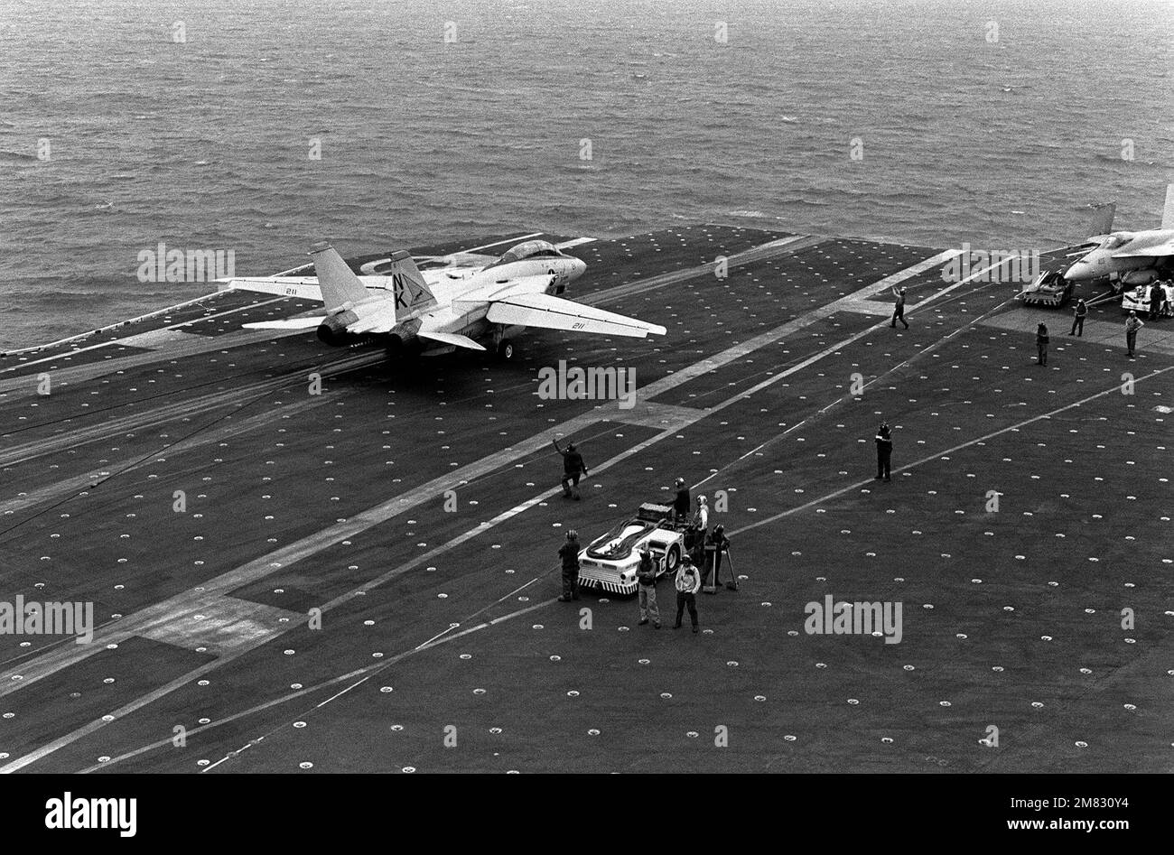 An F-14A Tomcat aircraft from Fighter Squadron 21 is stopped by the ...