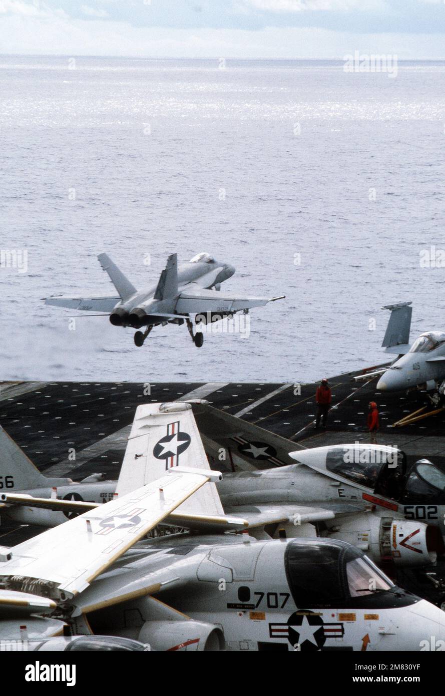An F/A-18 Hornet aircraft takes off from the aircraft carrier USS ...