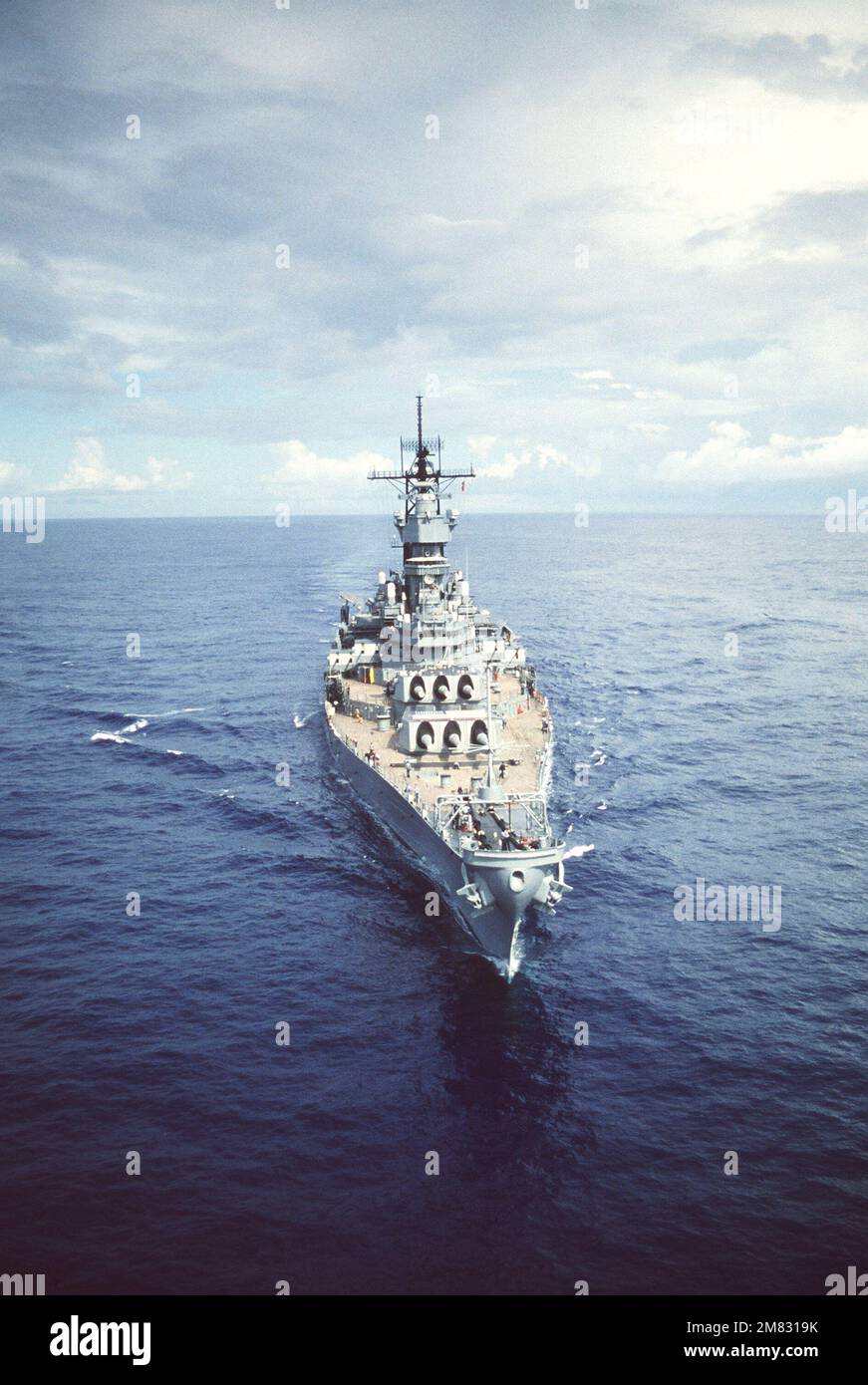 An elevated starboard bow view of the battleship USS IOWA (BB 61) underway. Country: Caribbean ...