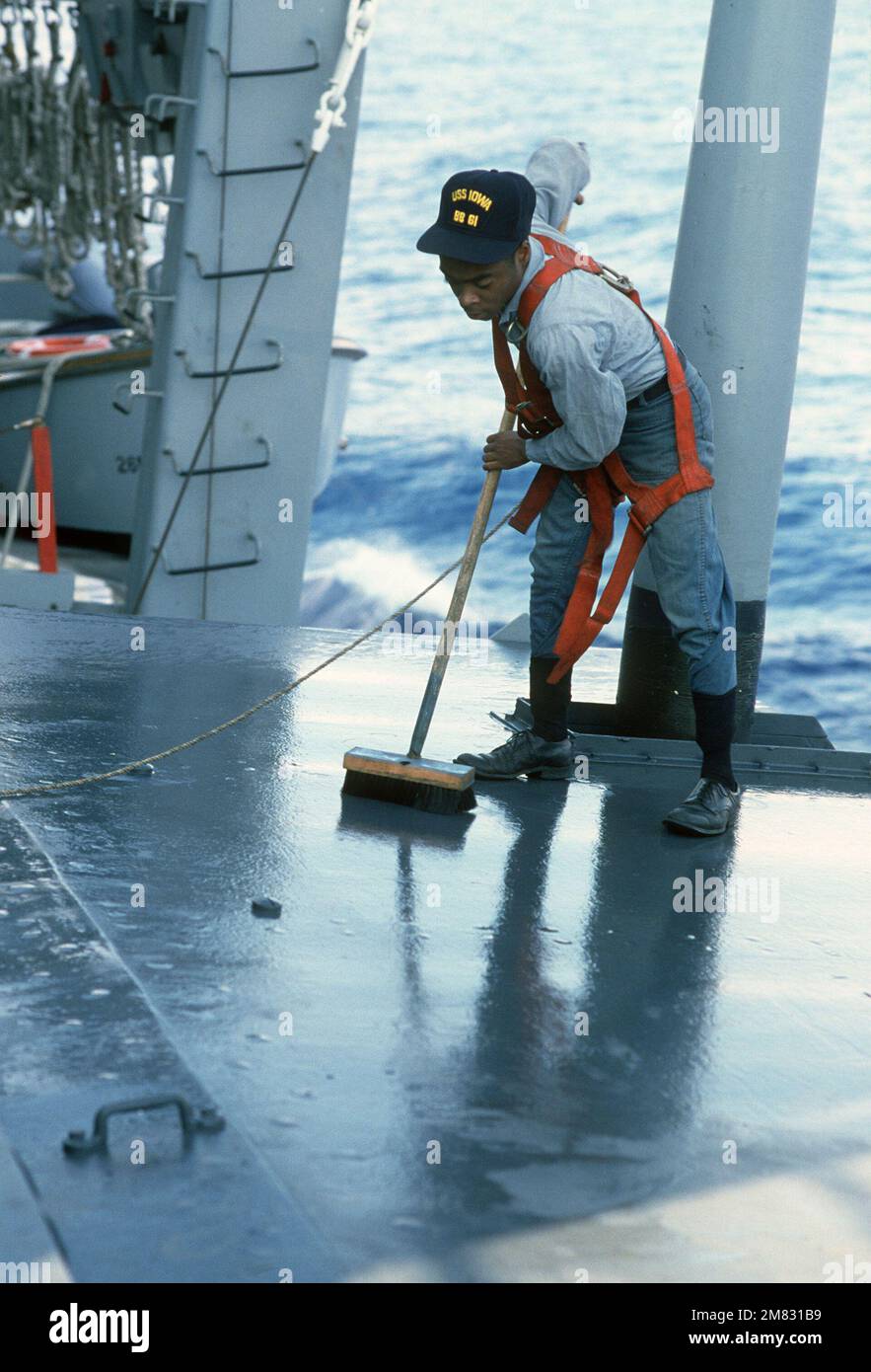 GUNNER's Mate (Guns) SEAMAN Timothy Youell scrubs the build up of salt ...