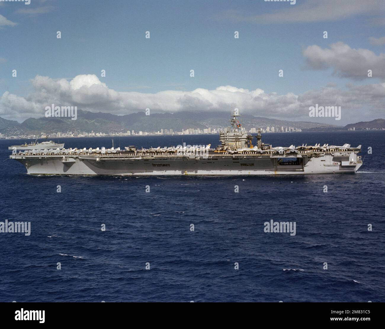 An elevated port beam view of the nuclear-powered aircraft carrier USS ...