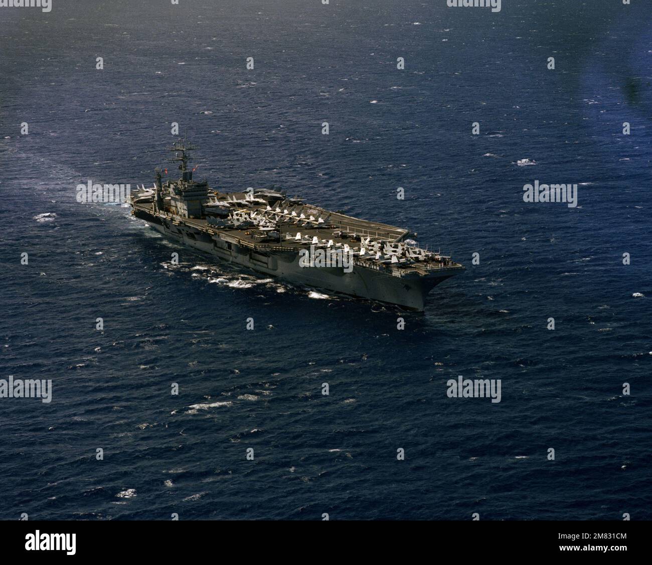 An elevated starboard bow view of the nuclear-powered aircraft carrier ...