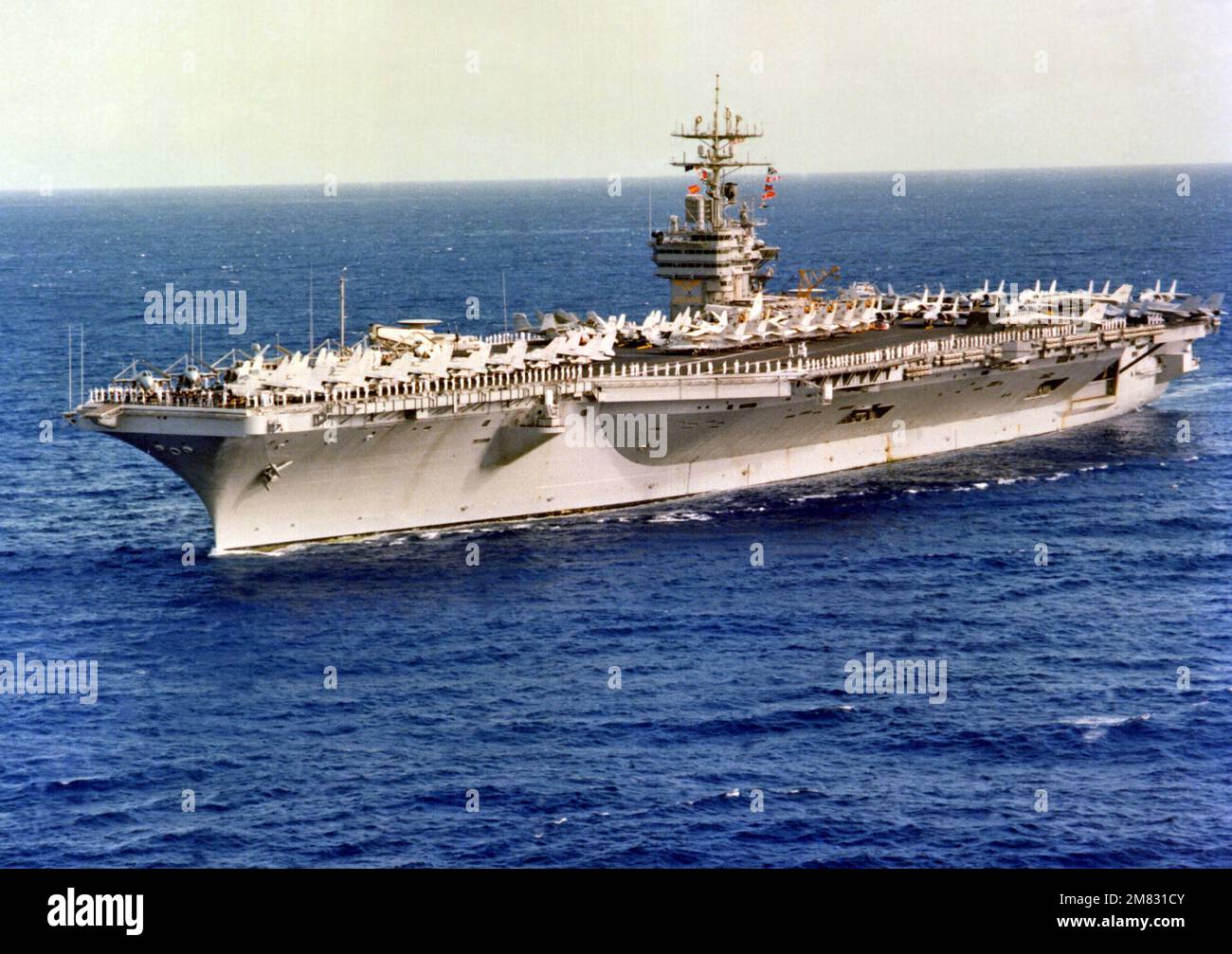 An elevated port bow view of the nuclear-powered aircraft carrier USS ...