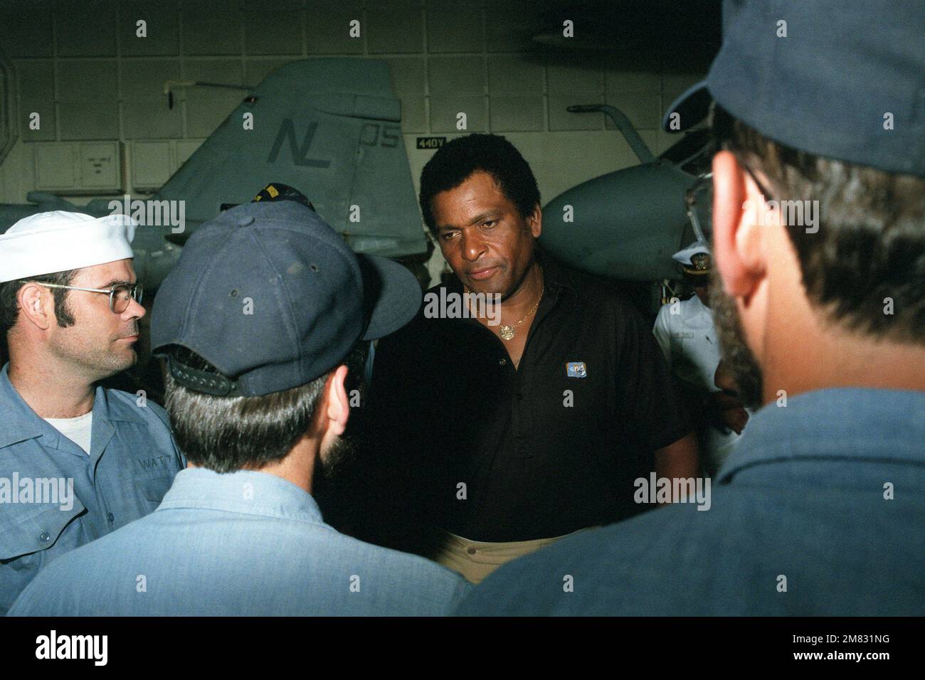 Country singer Charlie Pride visits with crew members aboard the ...