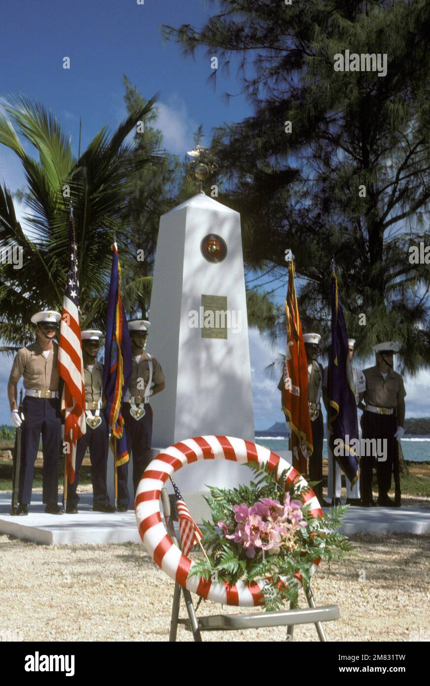 A joint Marine Corps/Navy color guard stands at attention at the ...