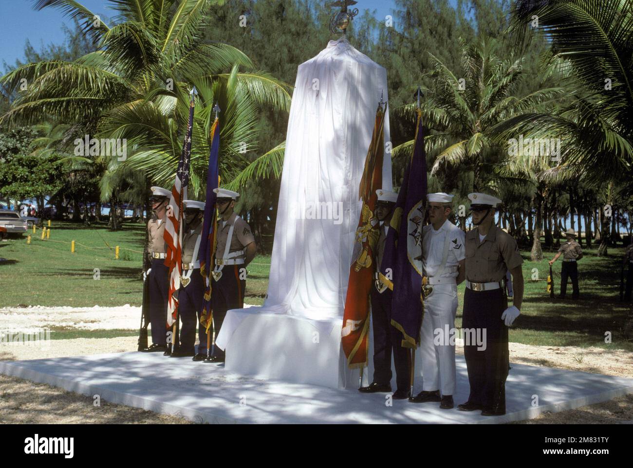A joint Marine Corps/Navy color guard stands at attention at the ...